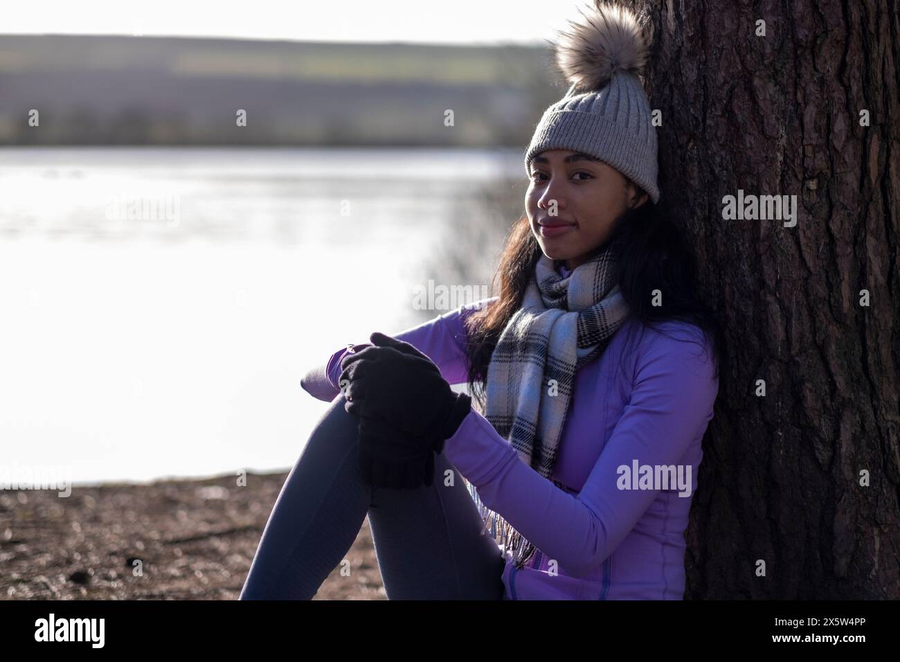 Sitting against tree hi-res stock photography and images - Alamy