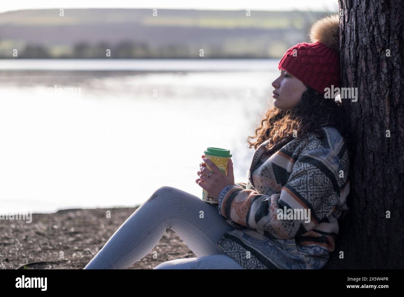 Woman sitting against tree trunk hi-res stock photography and images ...