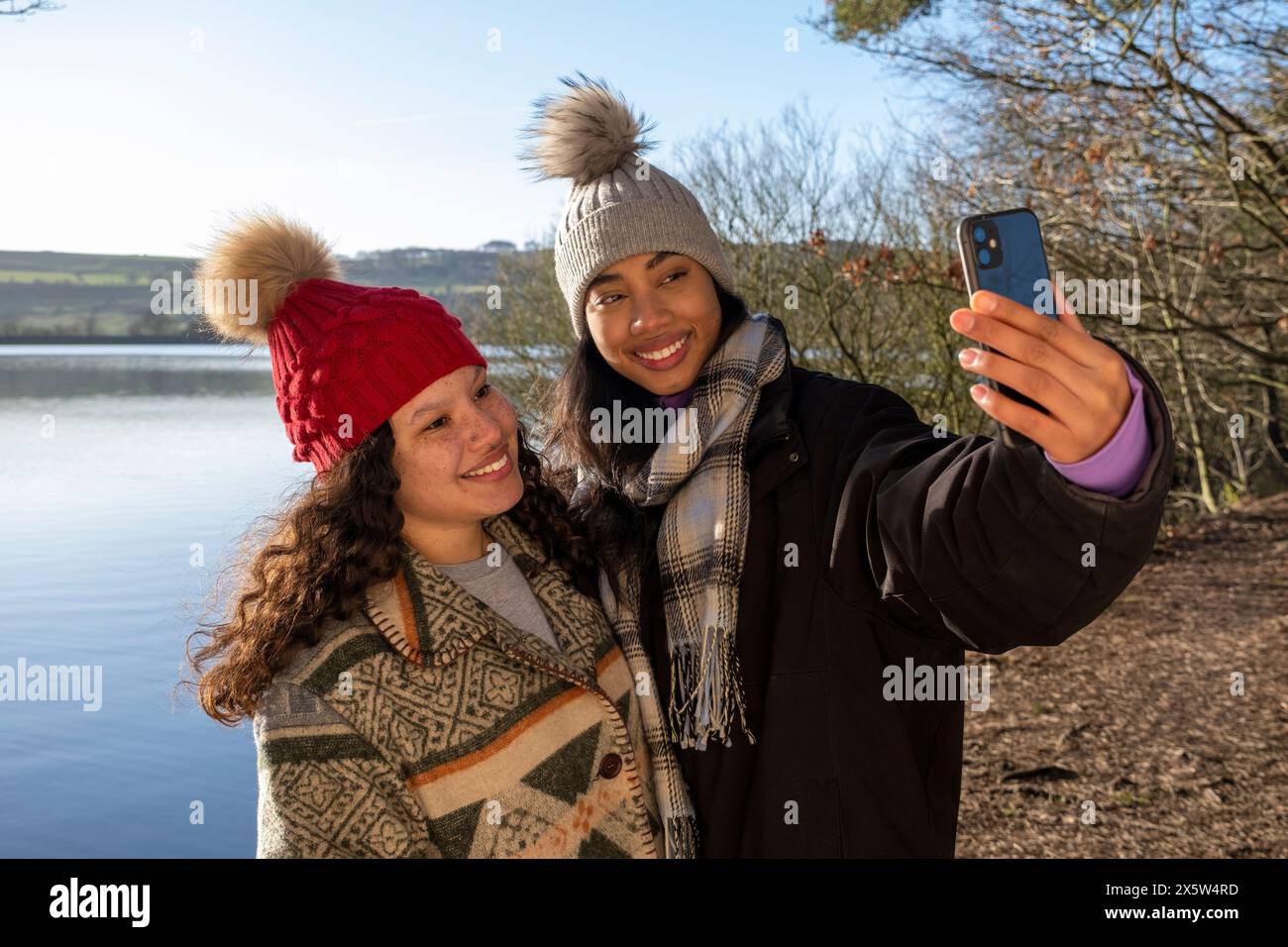 Female friends taking selfie at lake Stock Photo - Alamy Female friends taking selfie at lake Stock Photo - Alamy