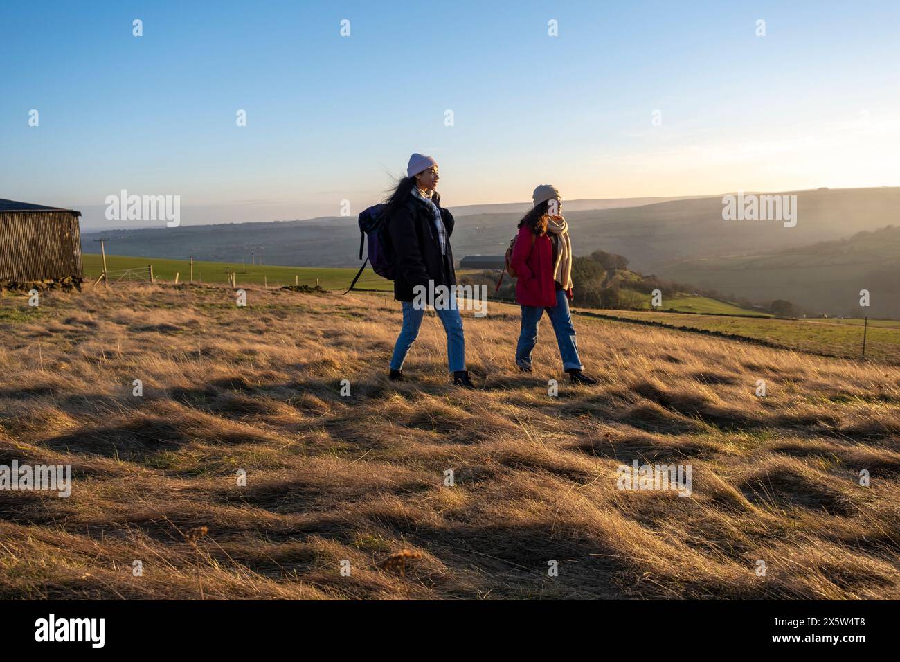 Female hikers walking in rural landscape Stock Photo - Alamy