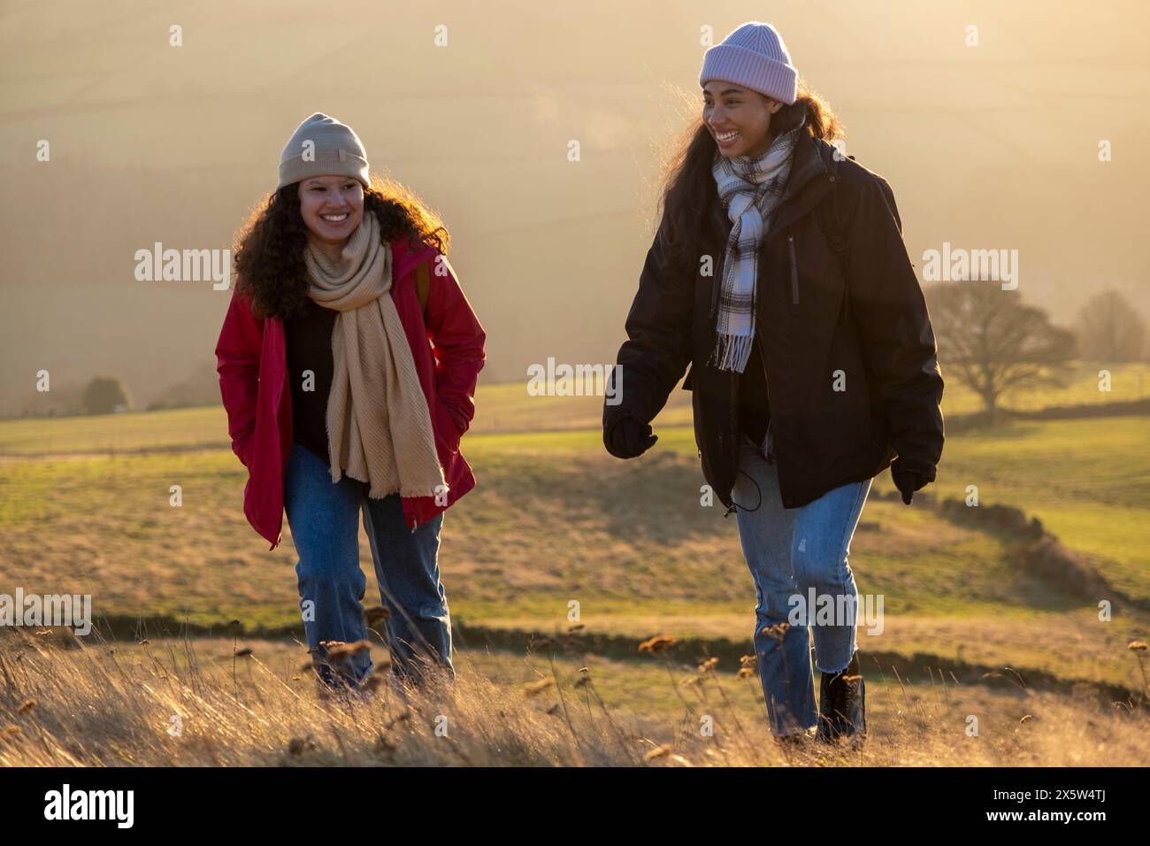 Female hikers walking in rural landscape Stock Photo - Alamy