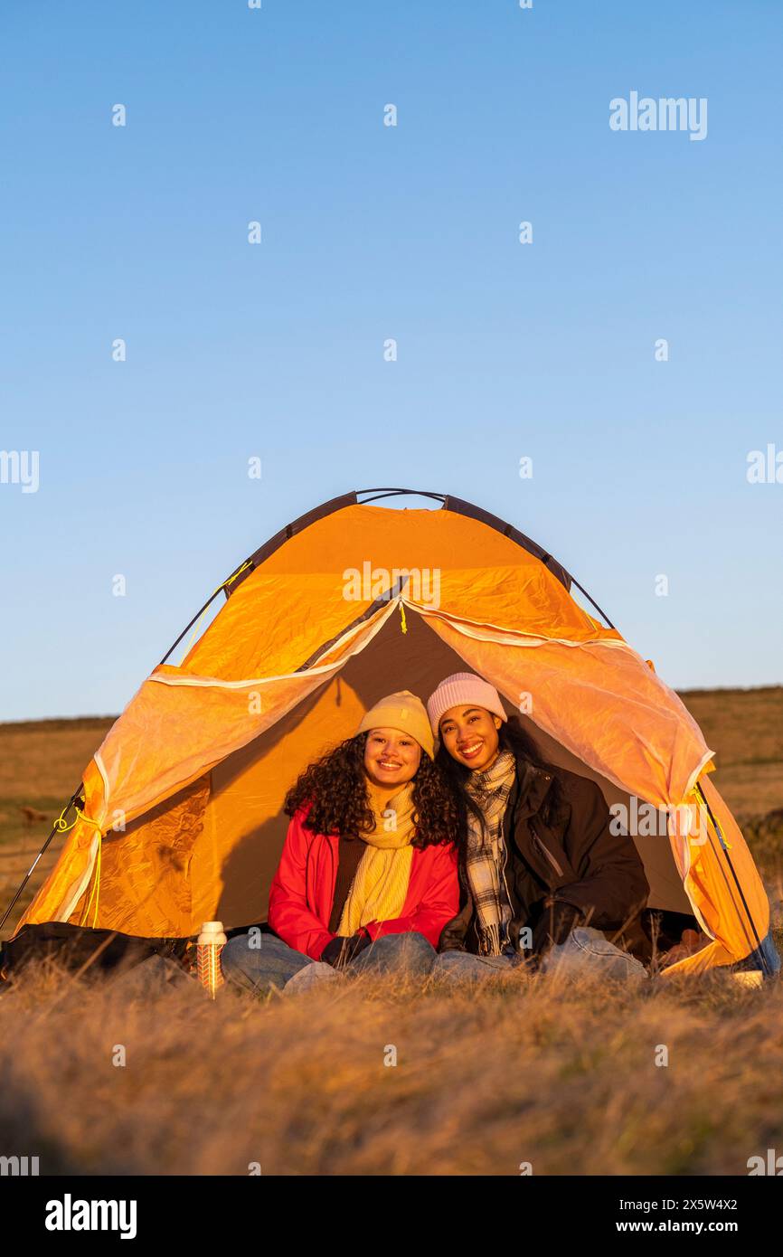 Portrait of female friends camping Stock Photo - Alamy