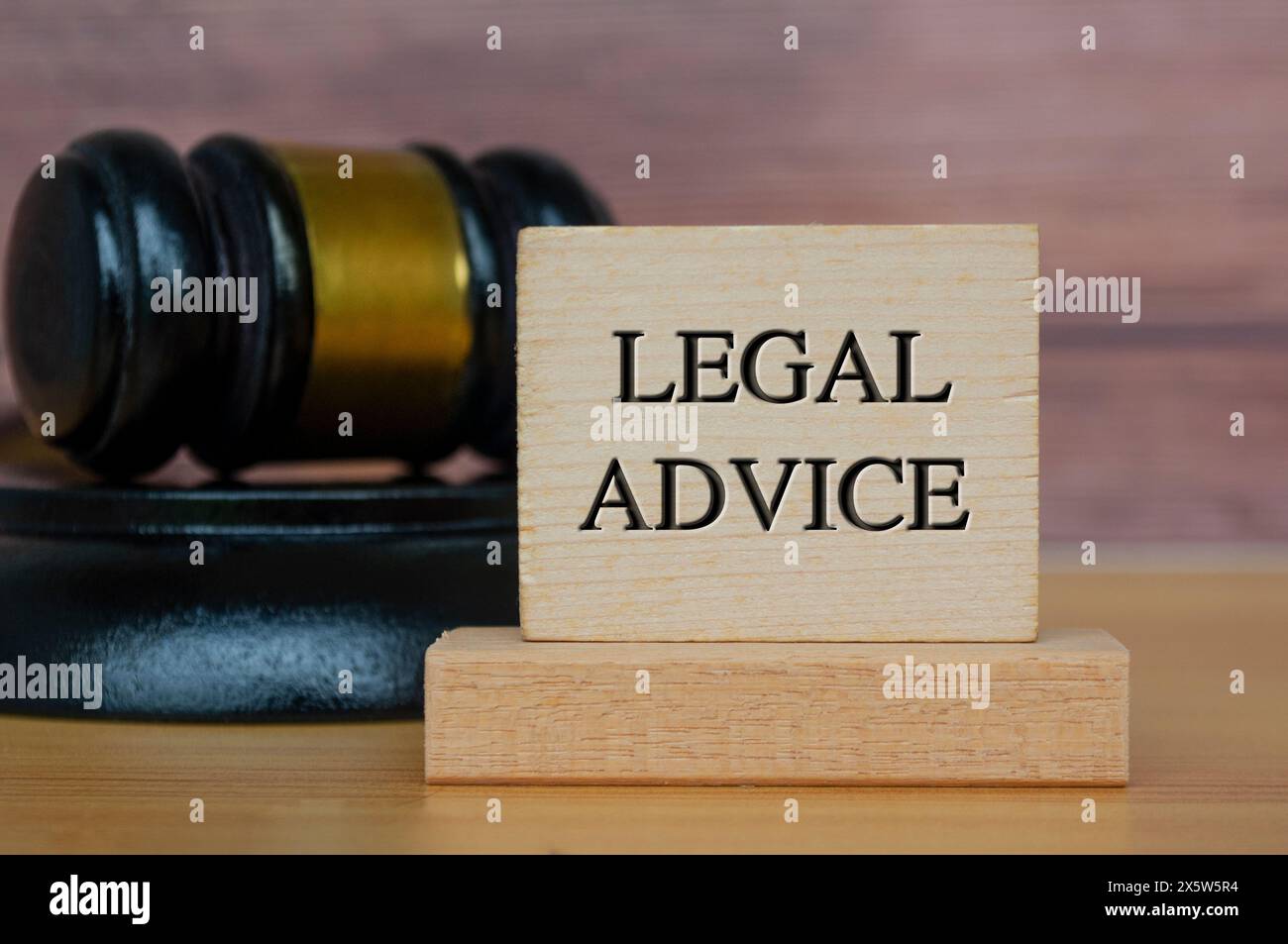 Legal advice text engraved on wooden block with gavel background. Legal ...