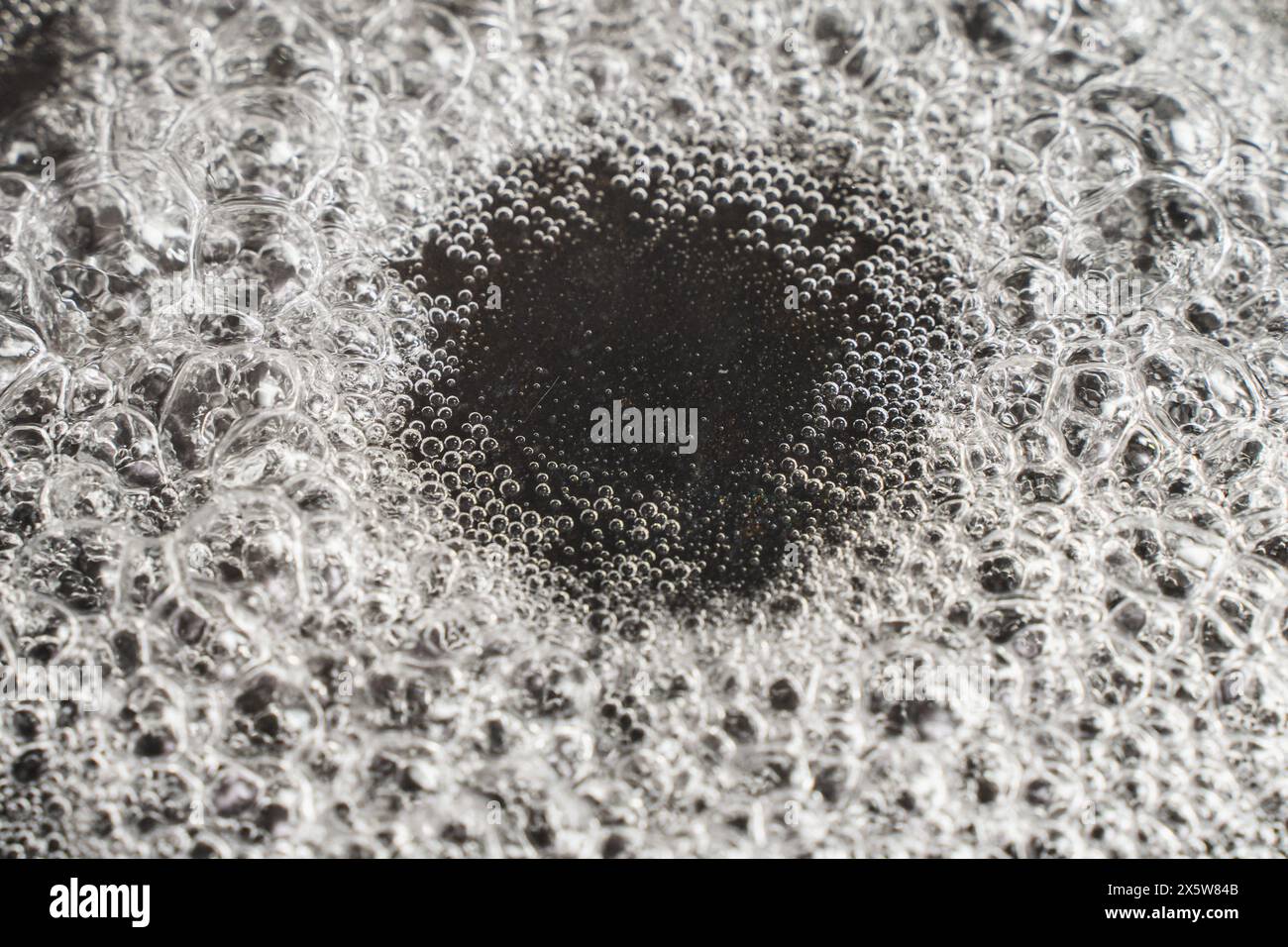 The background is boiling water in a black frying pan. The water ...