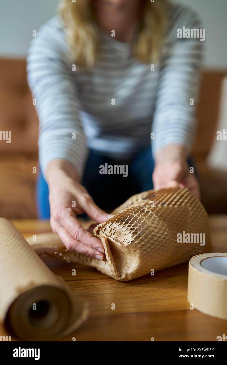 Woman Wrapping Parcel Protected With Green Environmentally Friendly ...