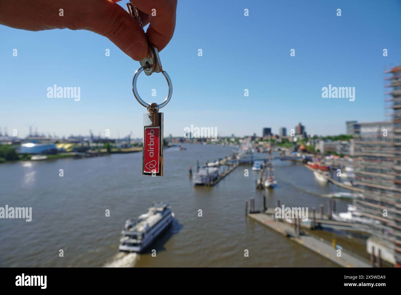 Hand holding Airbnb Key at Hamburg Harbor - Elbe View with Ships Stock ...