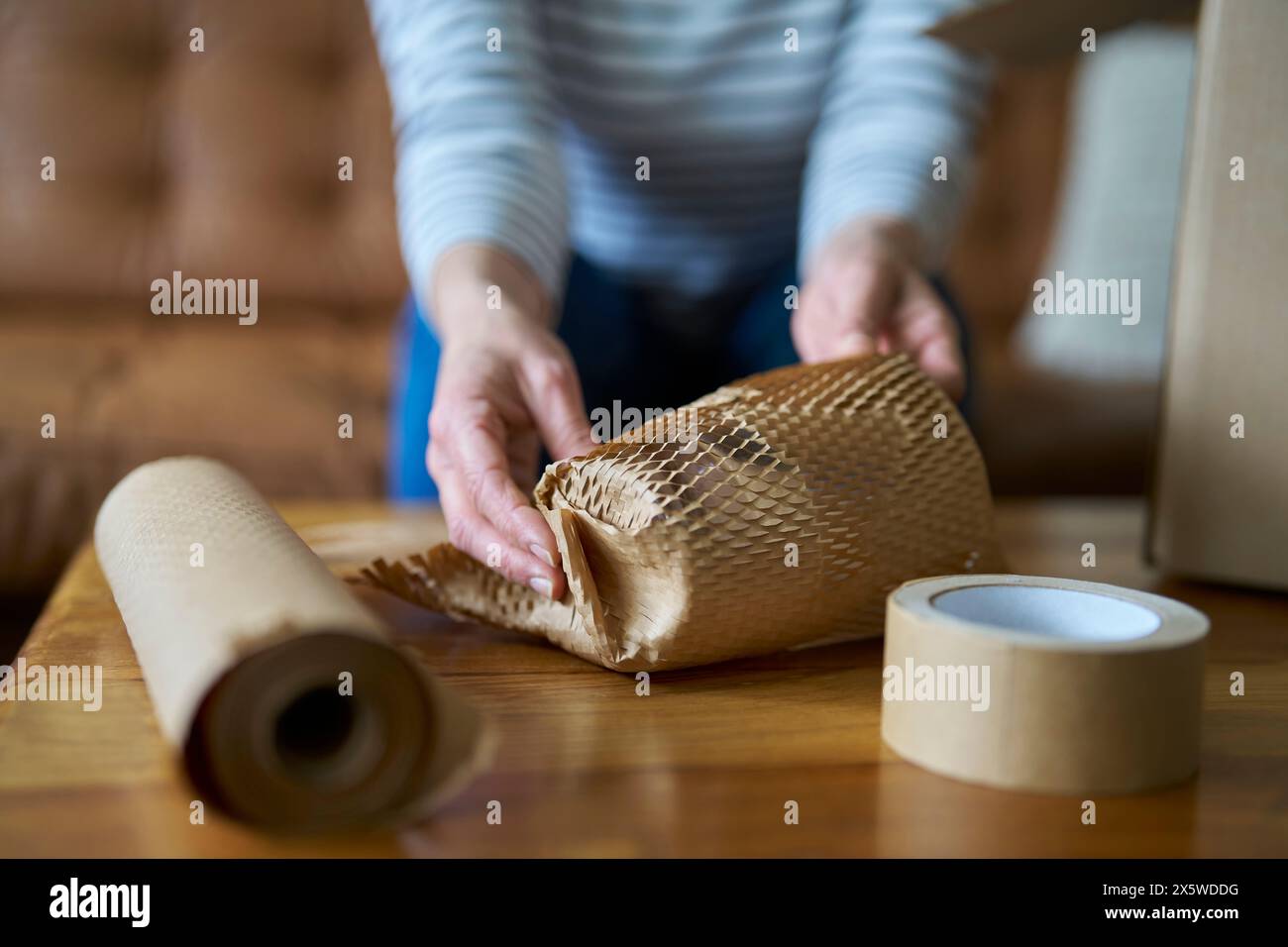 Woman Wrapping Parcel Protected With Green Environmentally Friendly ...