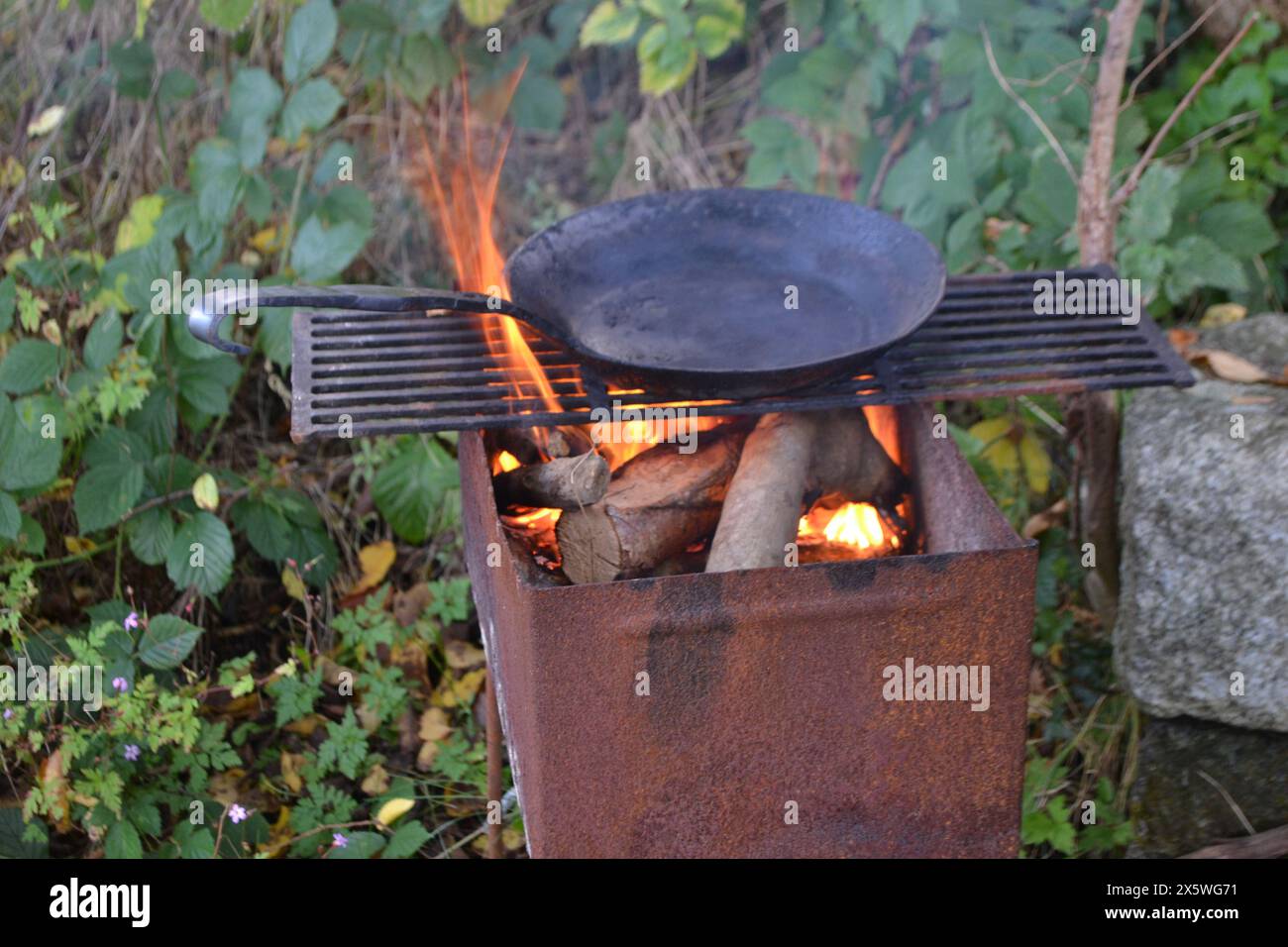 black skillet on a old wood fired barbecue Stock Photo - Alamy