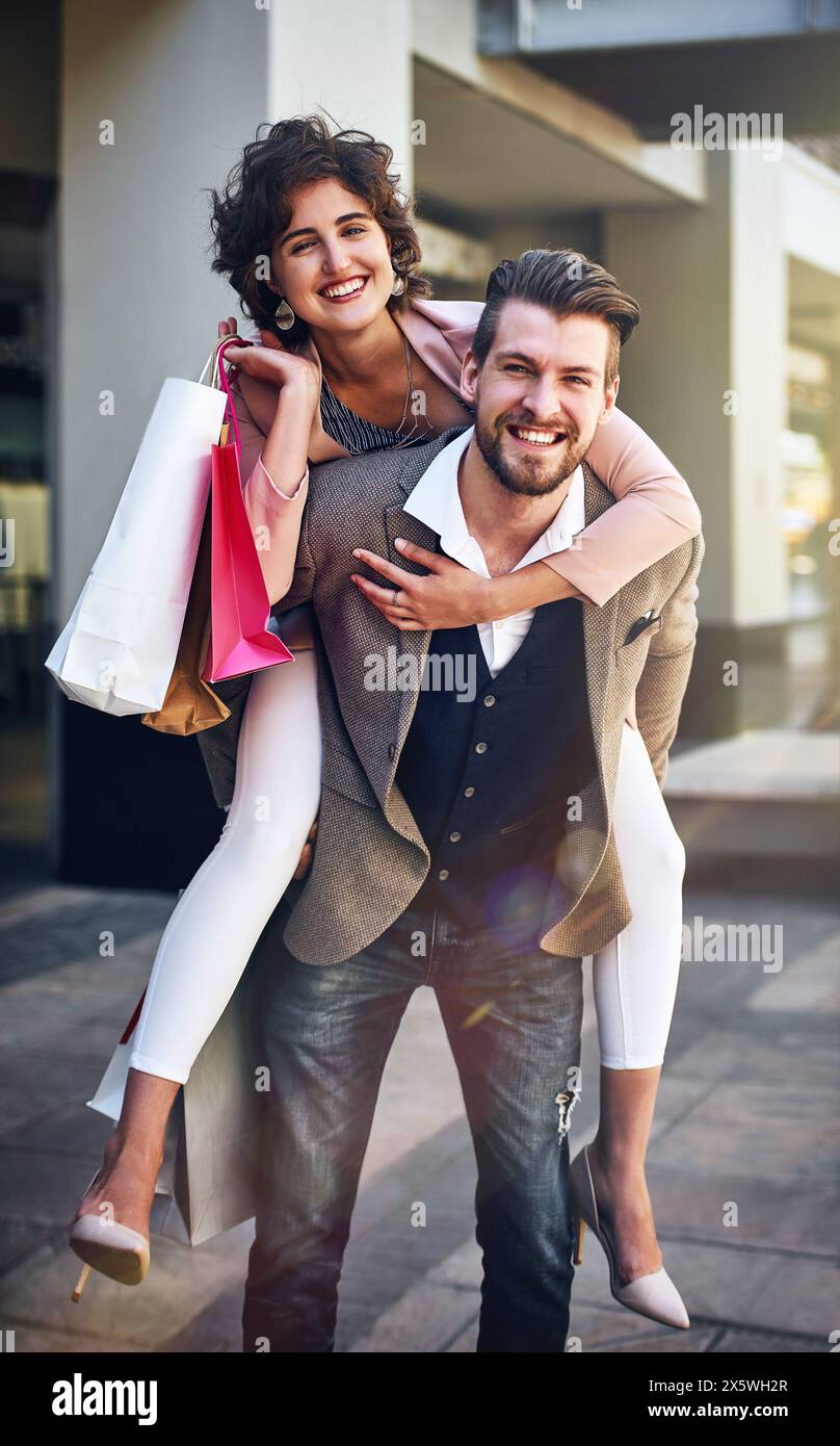 Shopping mall, piggy back and portrait of couple in city for clothing ...