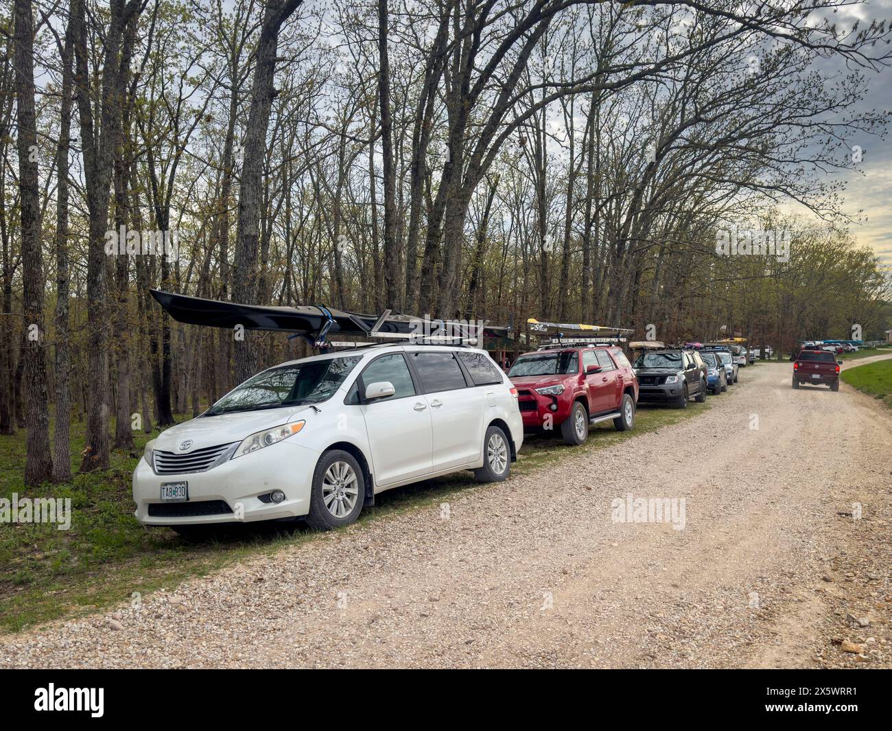 Rosebud, MO, USA - April 20, 2024: A row of cars with racing kayaks and ...