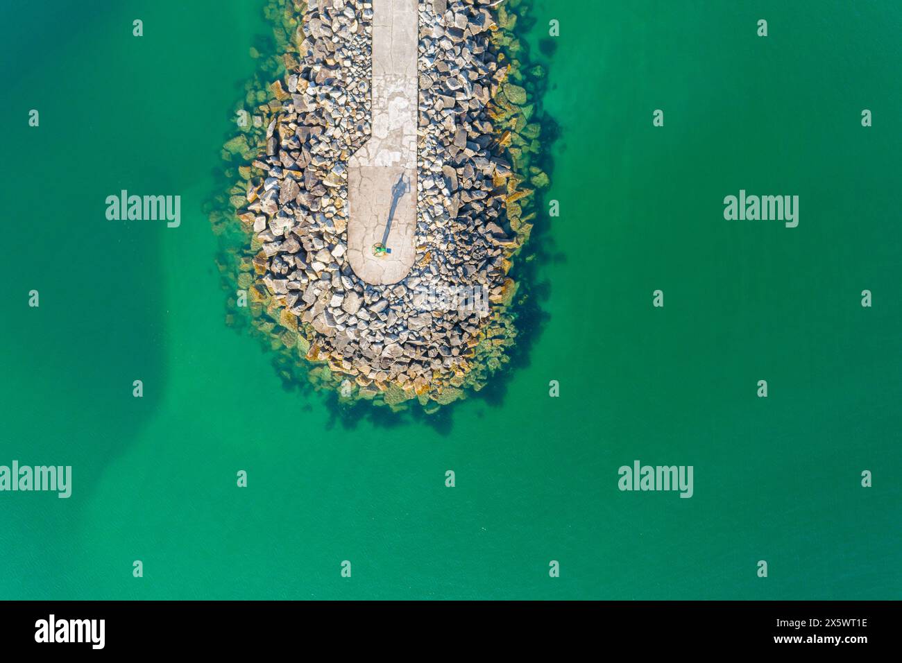 breakwater built with stone blocks in a sea of turquoise waters. Top ...