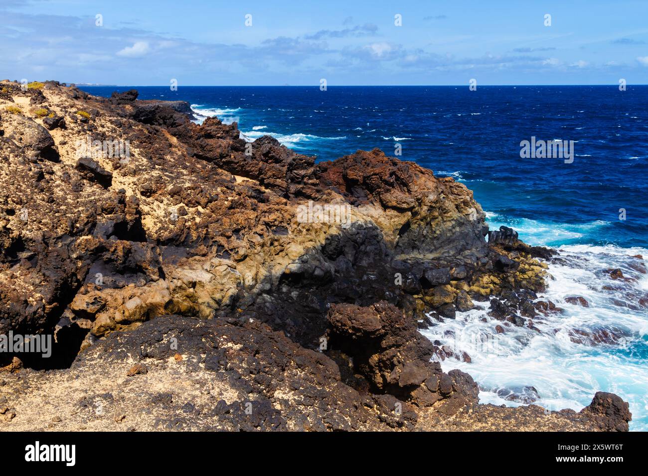 Rocky, volcanic Atlantic ocean coast. Charco de Palo region. Lanzarote ...