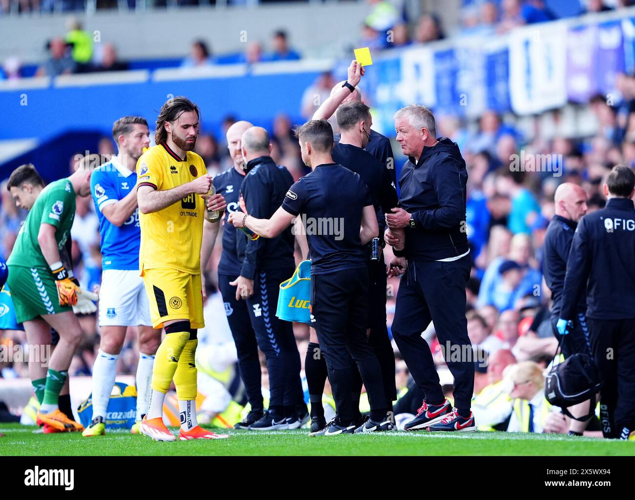 Referee Stuart Attwell (partially visible) shows a yellow card during ...
