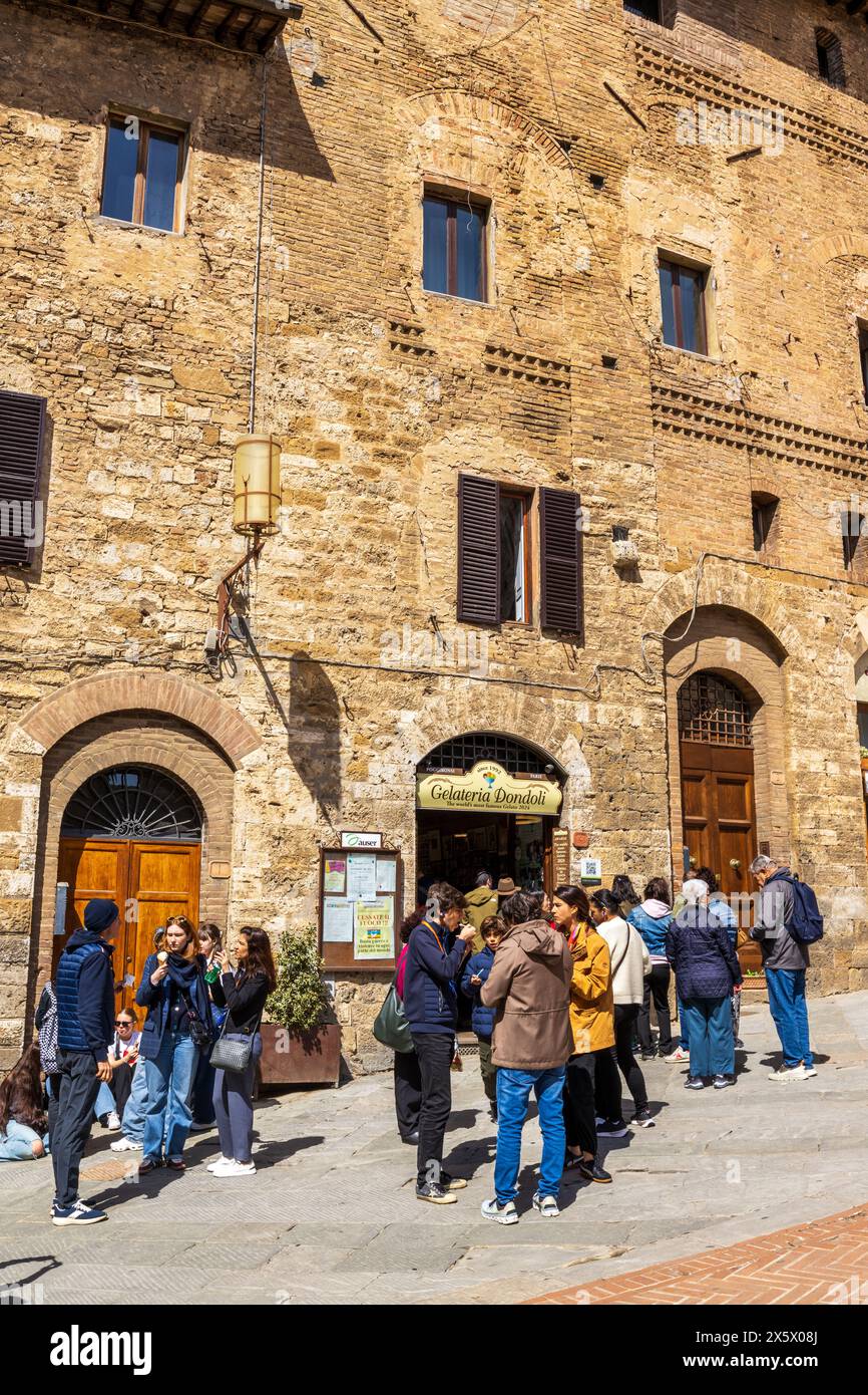 Tourists queuing outside the famous Gelateria Dondoli gelato shop and ...