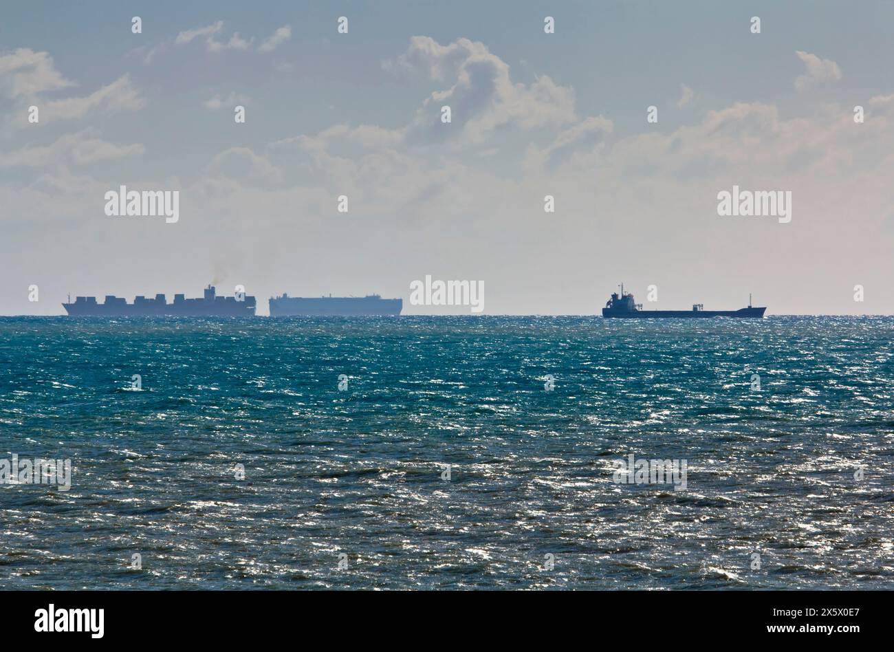 Italy, Sicily, Mediterranean sea, cargo ships and an oil thank in the ...