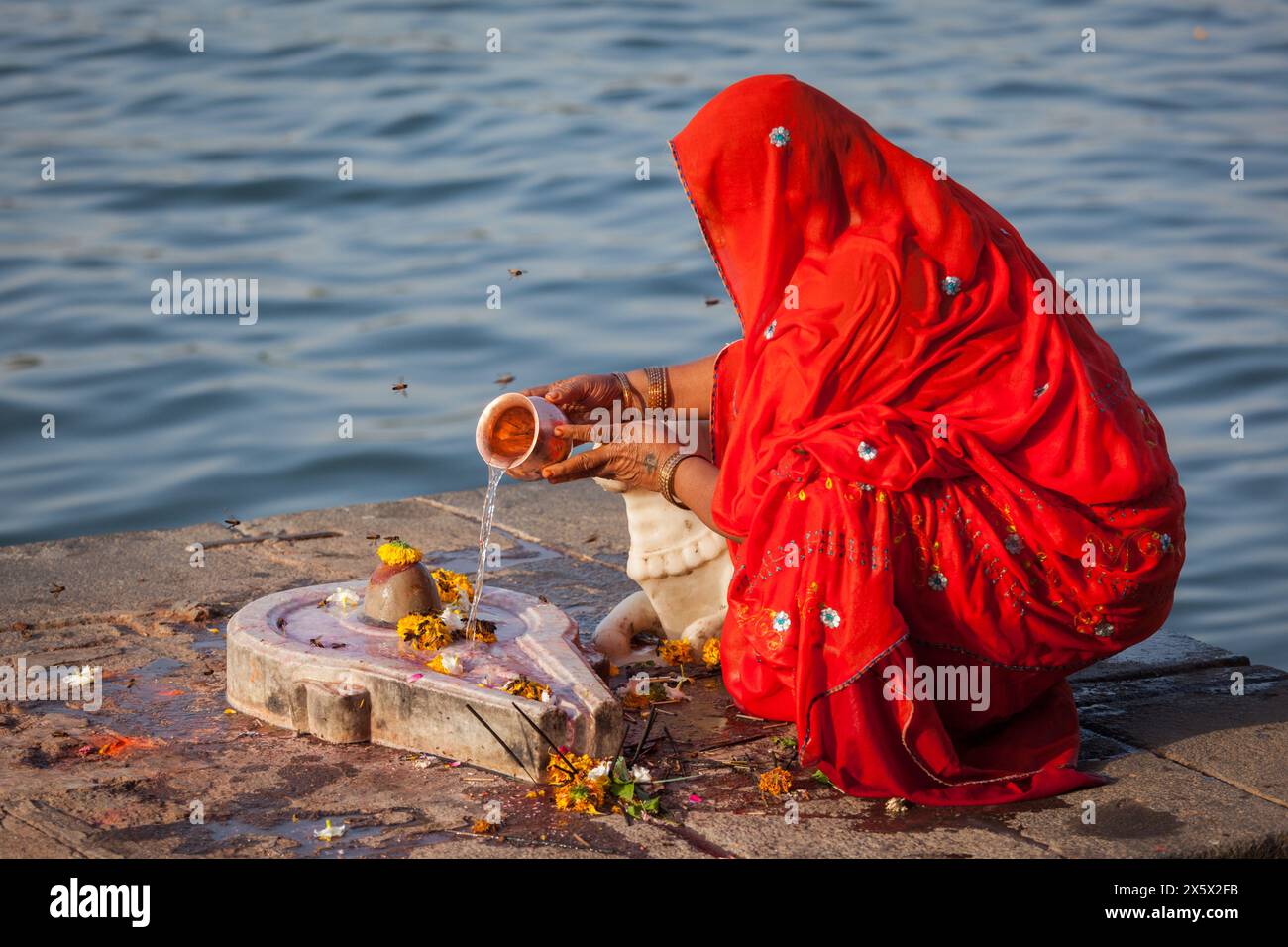 Indian woman performs morning pooja on holy river Narmada ghats Stock ...