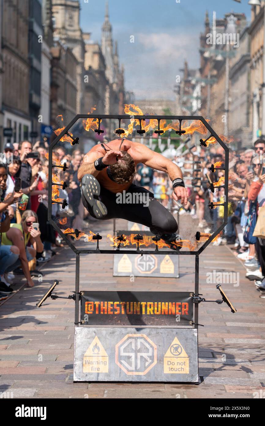 Glasgow, Scotland, UK. 11th May, 2024. Liam Collins aka the Stunt Runner, jumping through ...