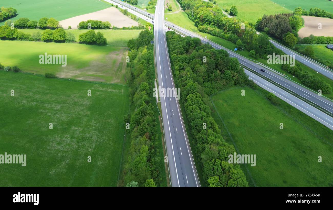 Drone view of a highway in Germany with a lot of traffic and many green ...