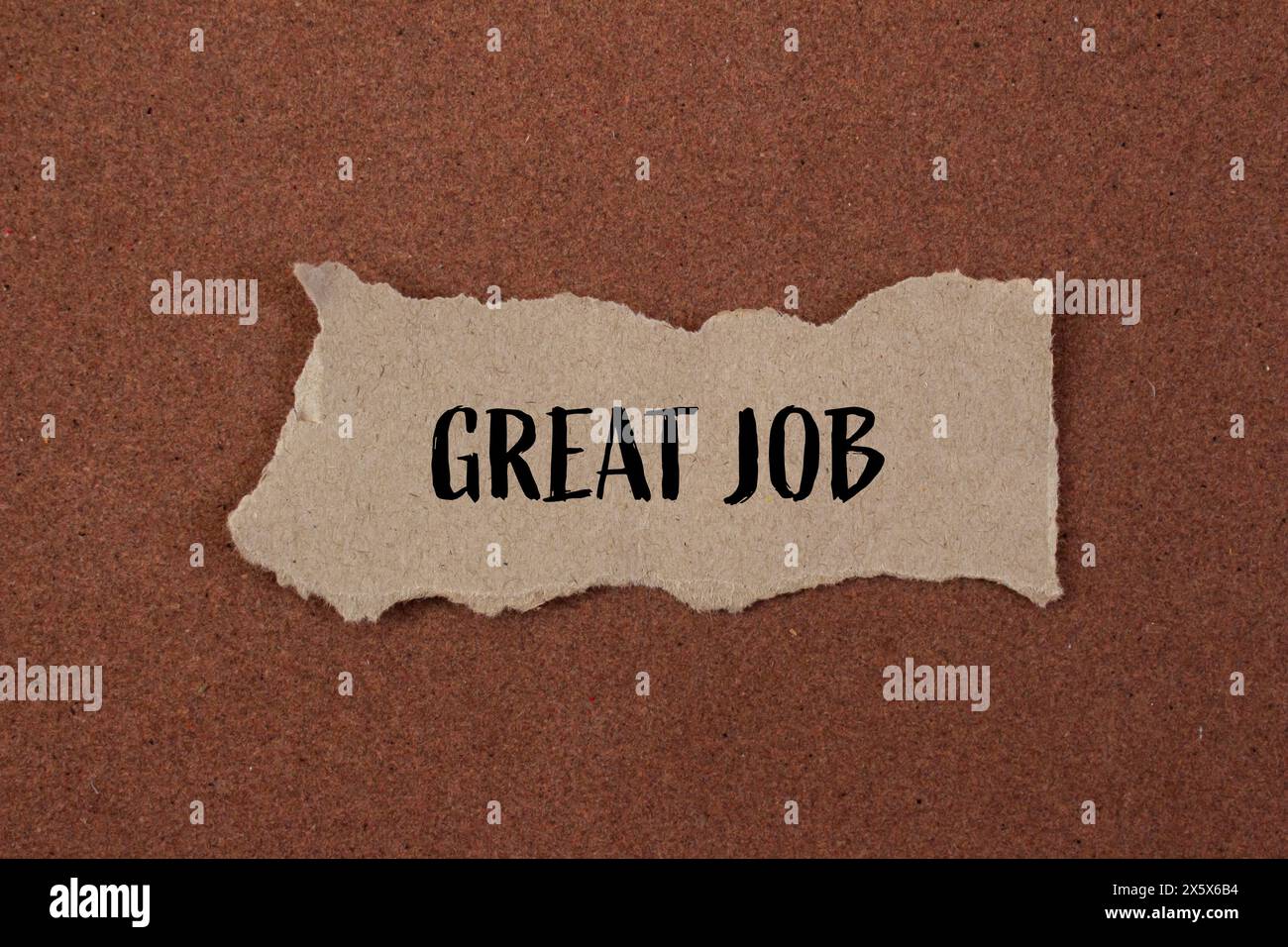 Great job written on ripped paper piece with brown background ...