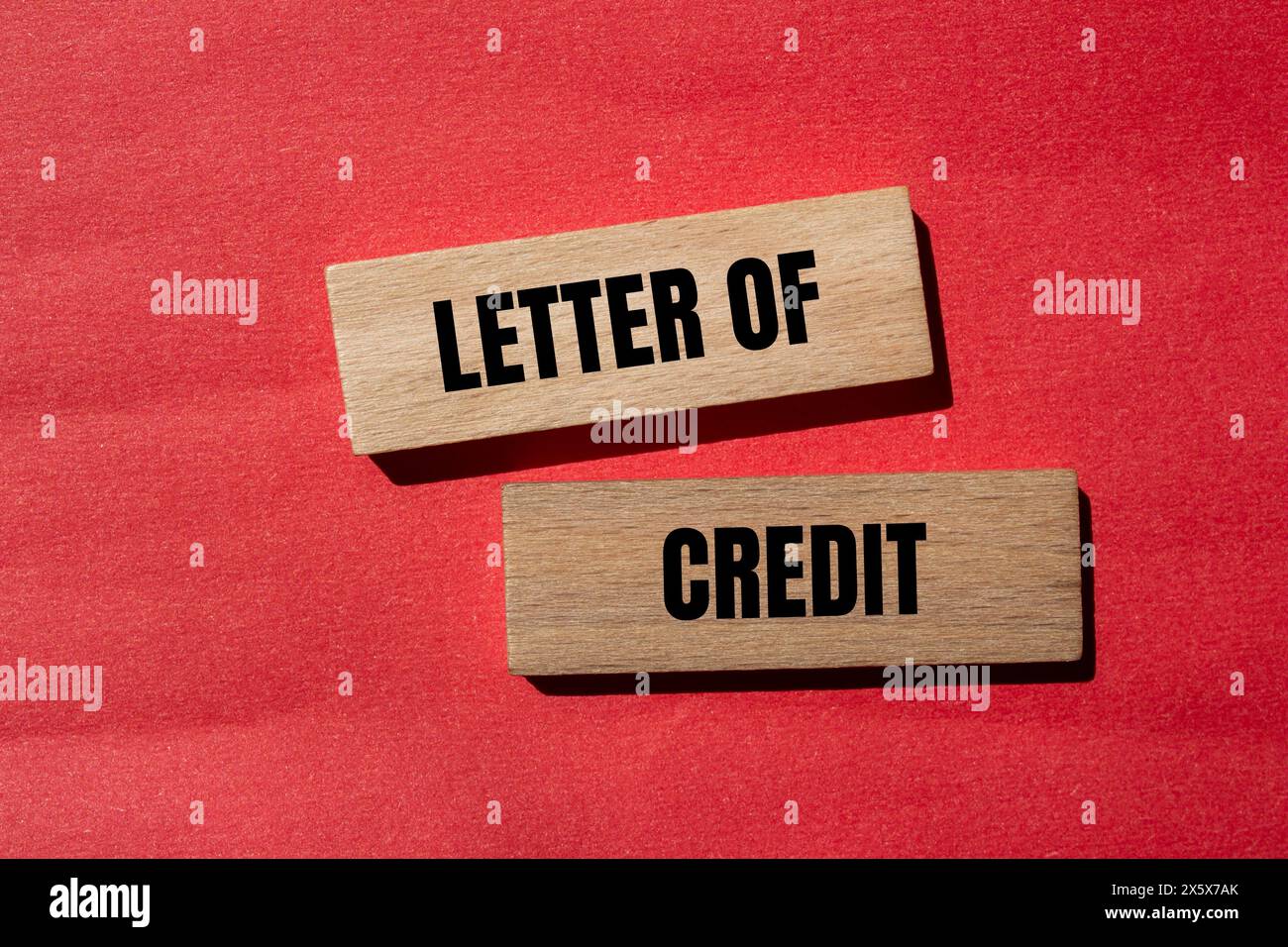 Letter of credit words written on wooden blocks with red background ...