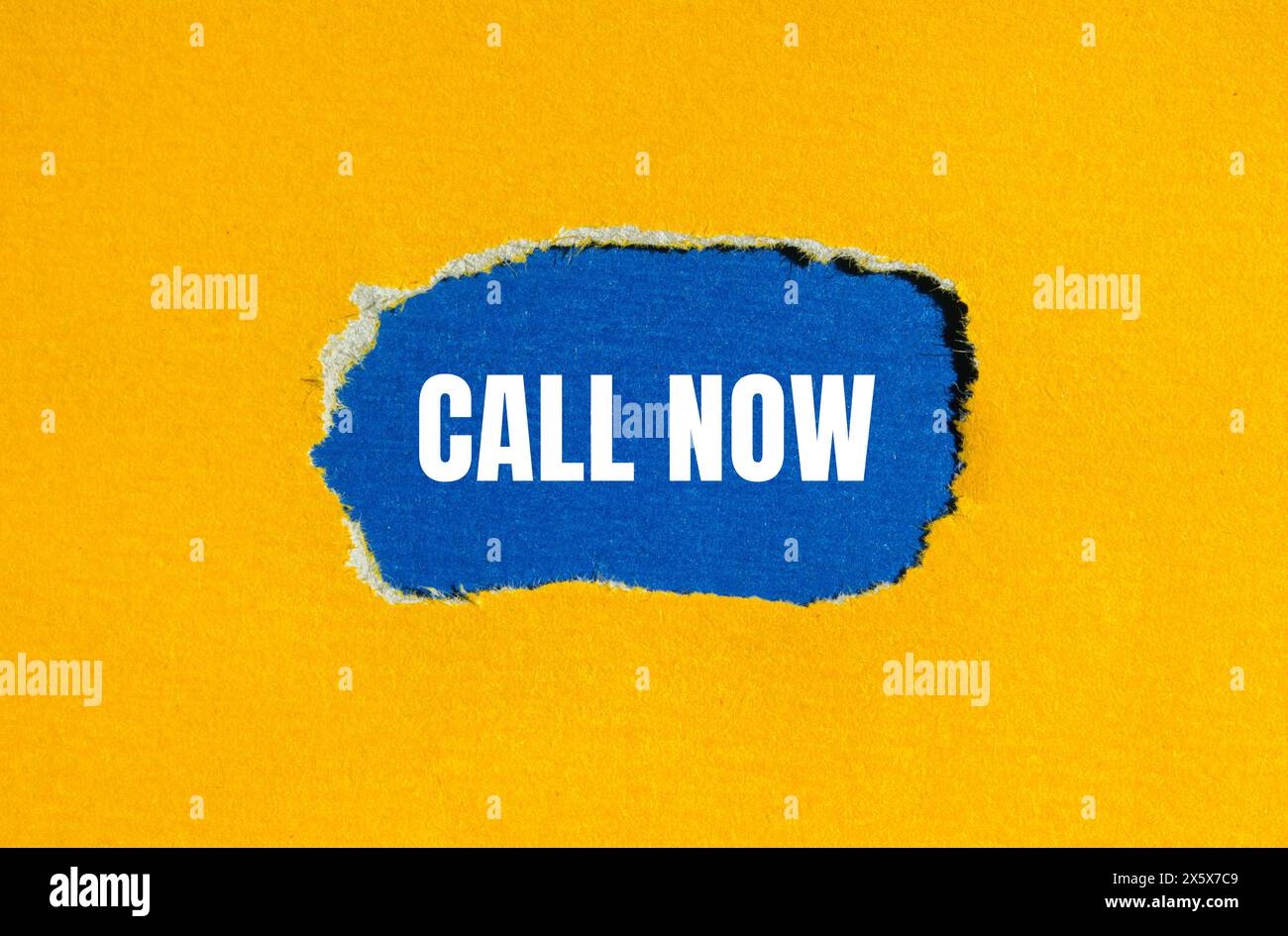 Call now words written on ripped yellow paper with blue background ...