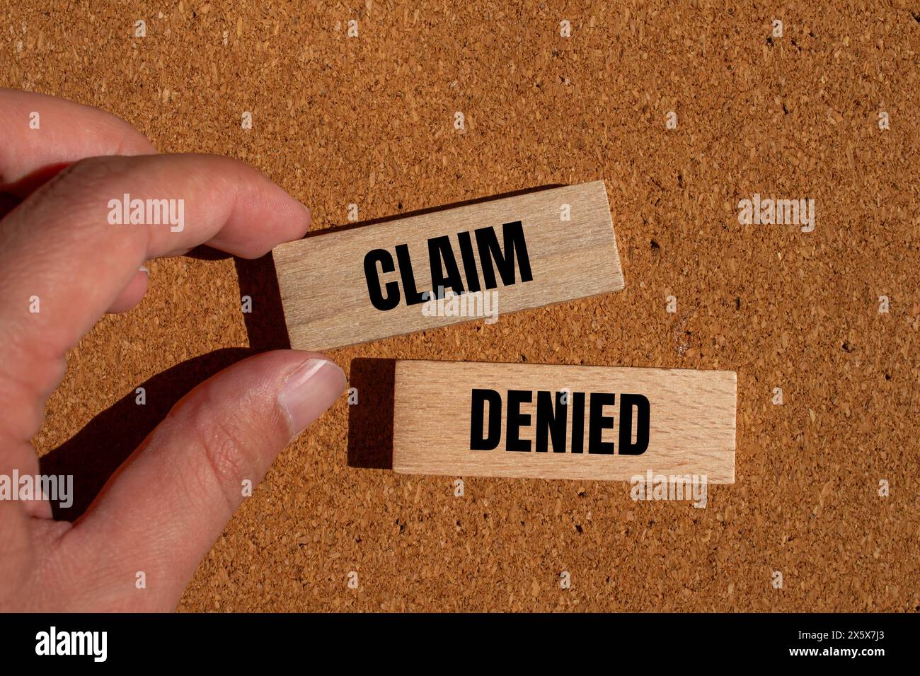 Claim denied words written on wooden blocks with brown background ...