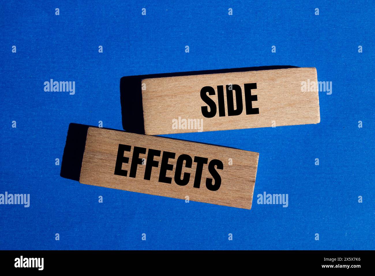 Side effects words written on wooden blocks with blue background ...