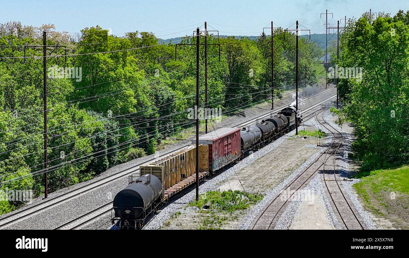 An engaging aerial view of a freight train carrying diverse cargo ...