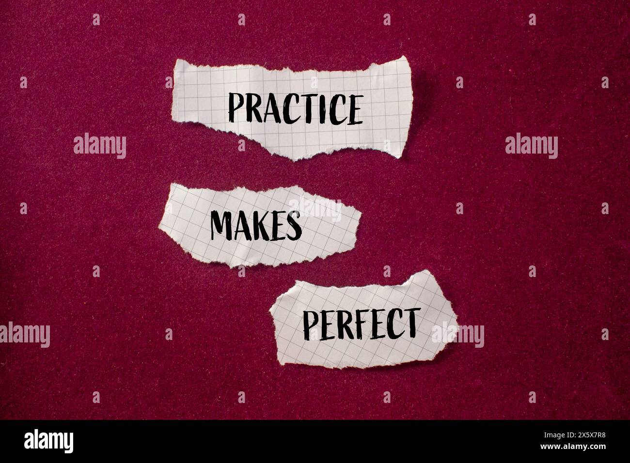 Practice makes perfect words written on ripped white paper pieces with ...