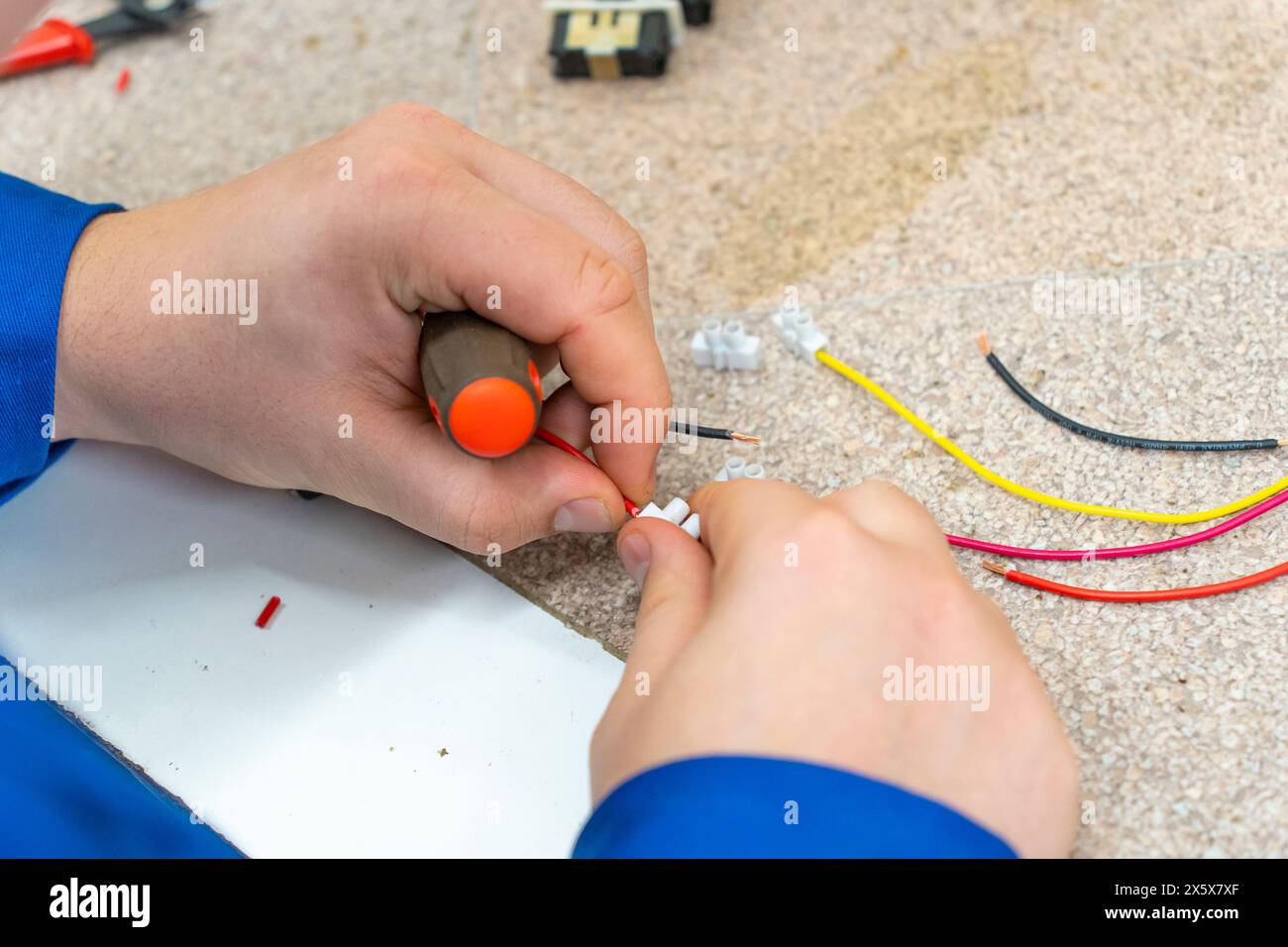A man doing electronic assembly with colored wires Stock Photo - Alamy