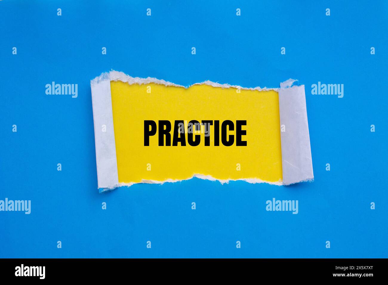 Practice word written on ripped blue paper with yellow background ...