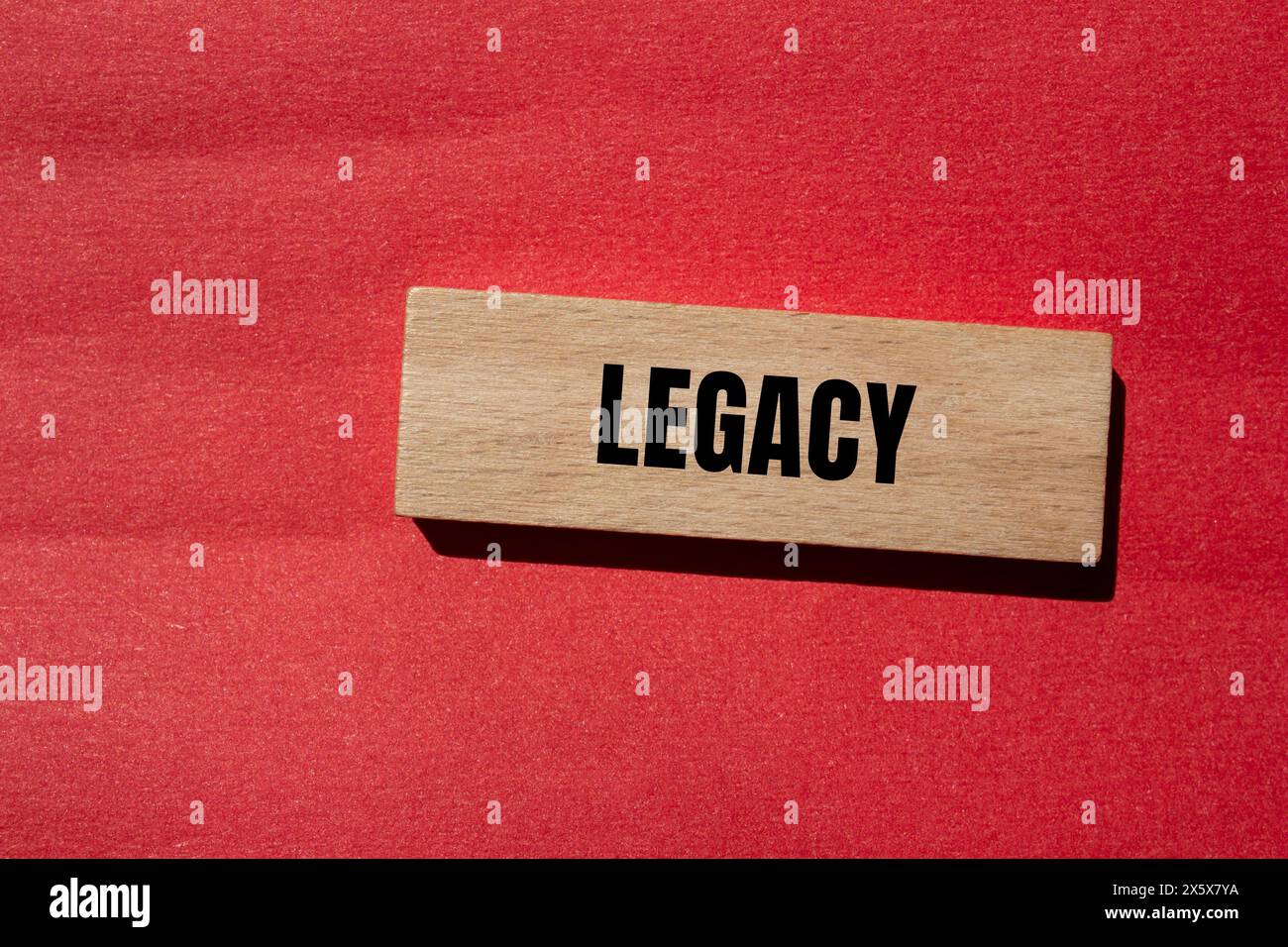 Legacy word written on wooden block with red background. Conceptual ...