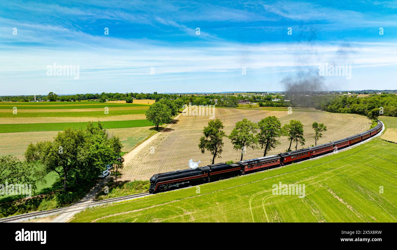 Aerial image of a classic steam train curving through the countryside ...