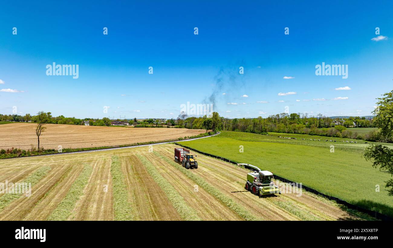 An aerial shot displaying intense harvesting activity with machinery in ...