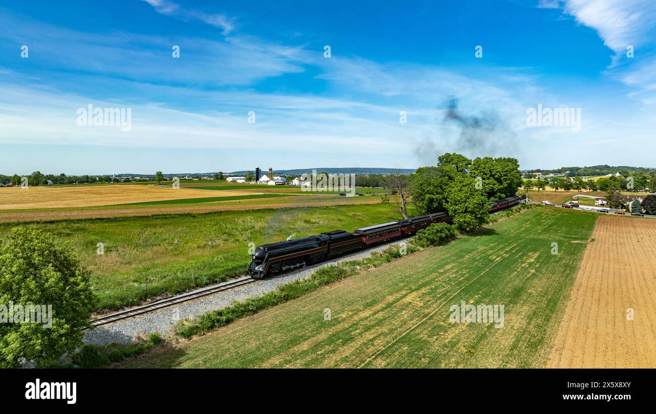A striking aerial view showcasing a historic train cutting across ...