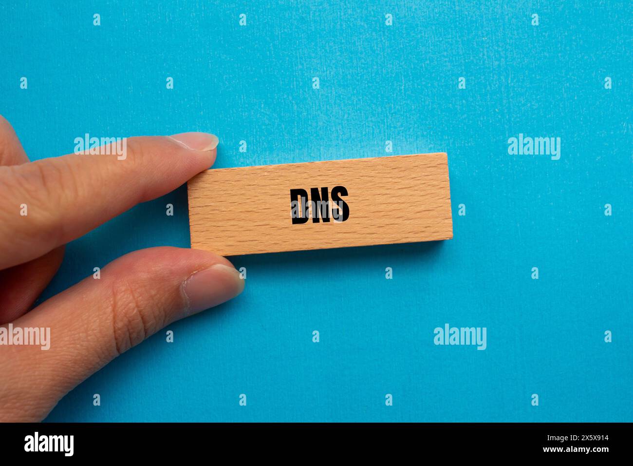 DNS word written on wooden block with blue background. Conceptual DNS ...