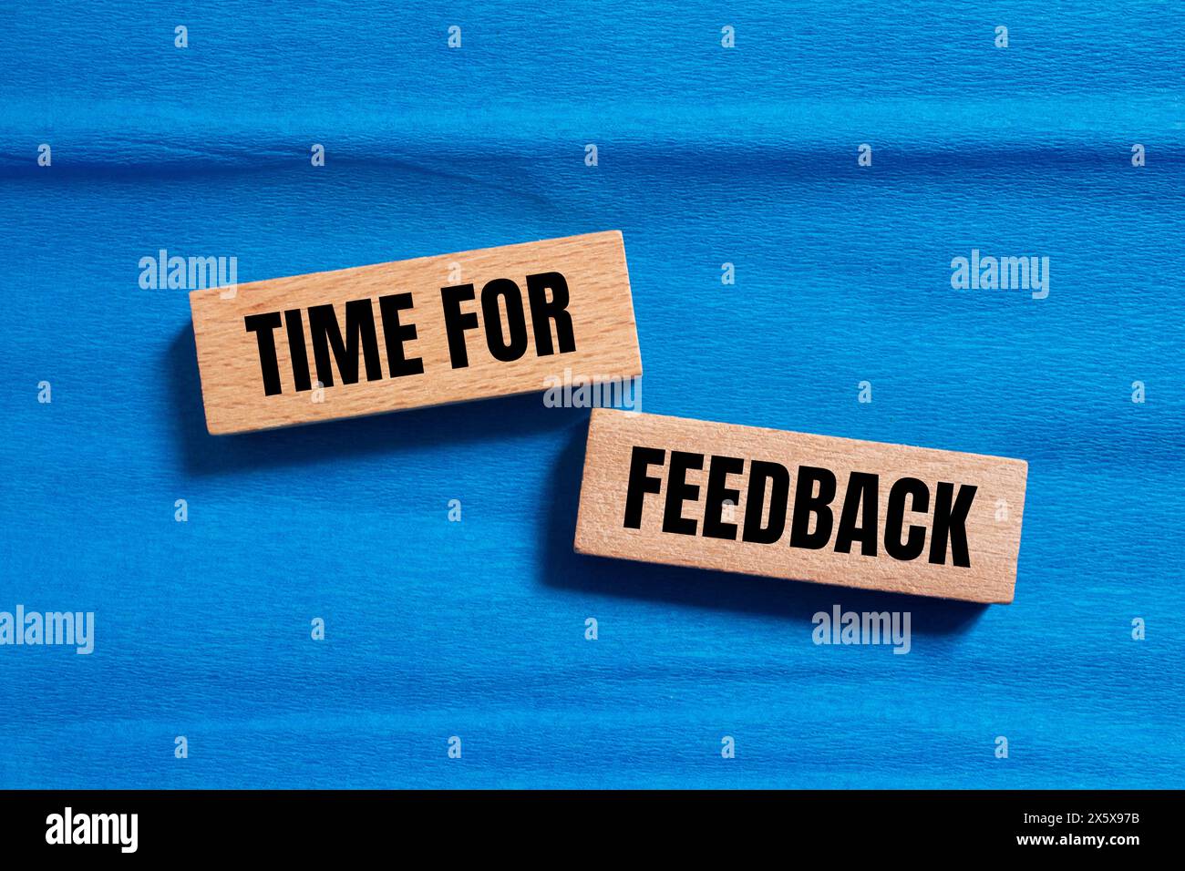 Time for feedback words written on wooden blocks with blue background ...