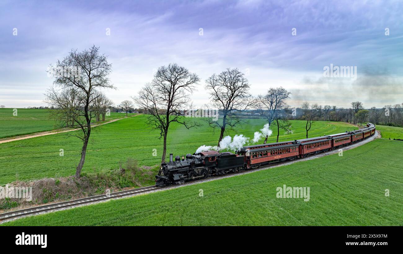 Eye-catching aerial image of a classic steam locomotive pulling red ...