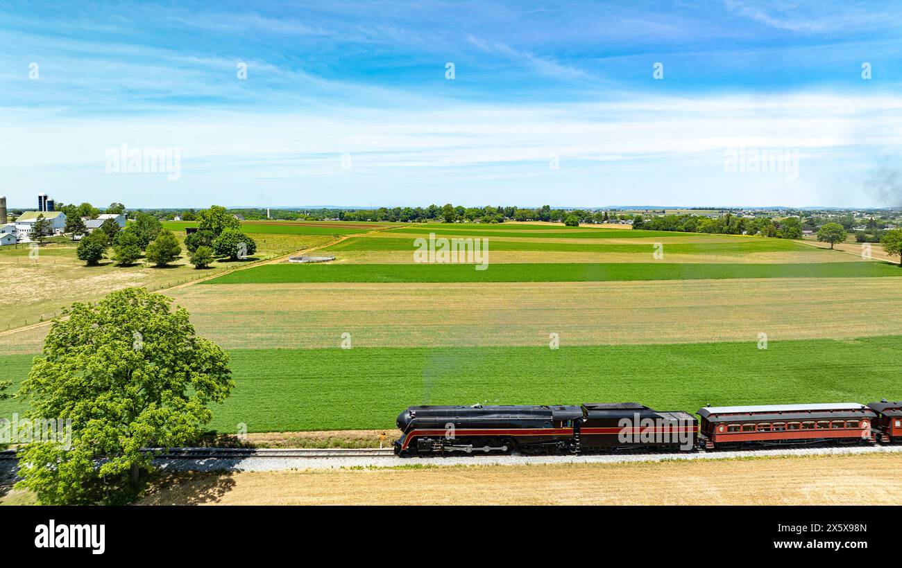 Stunning aerial view of a classic train passing through expansive ...