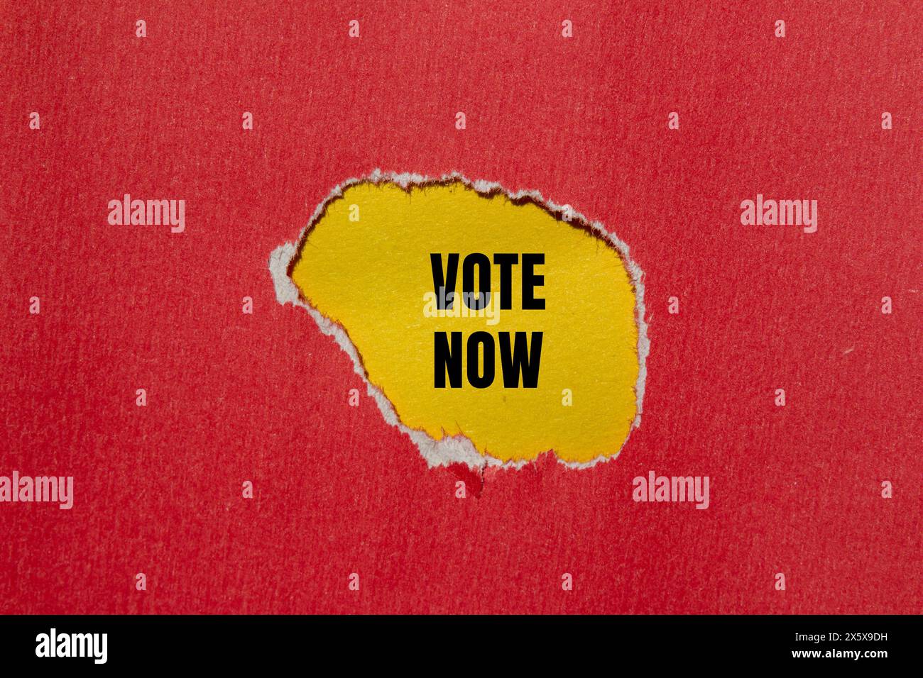 Vote now words written on ripped red paper with yellow background ...