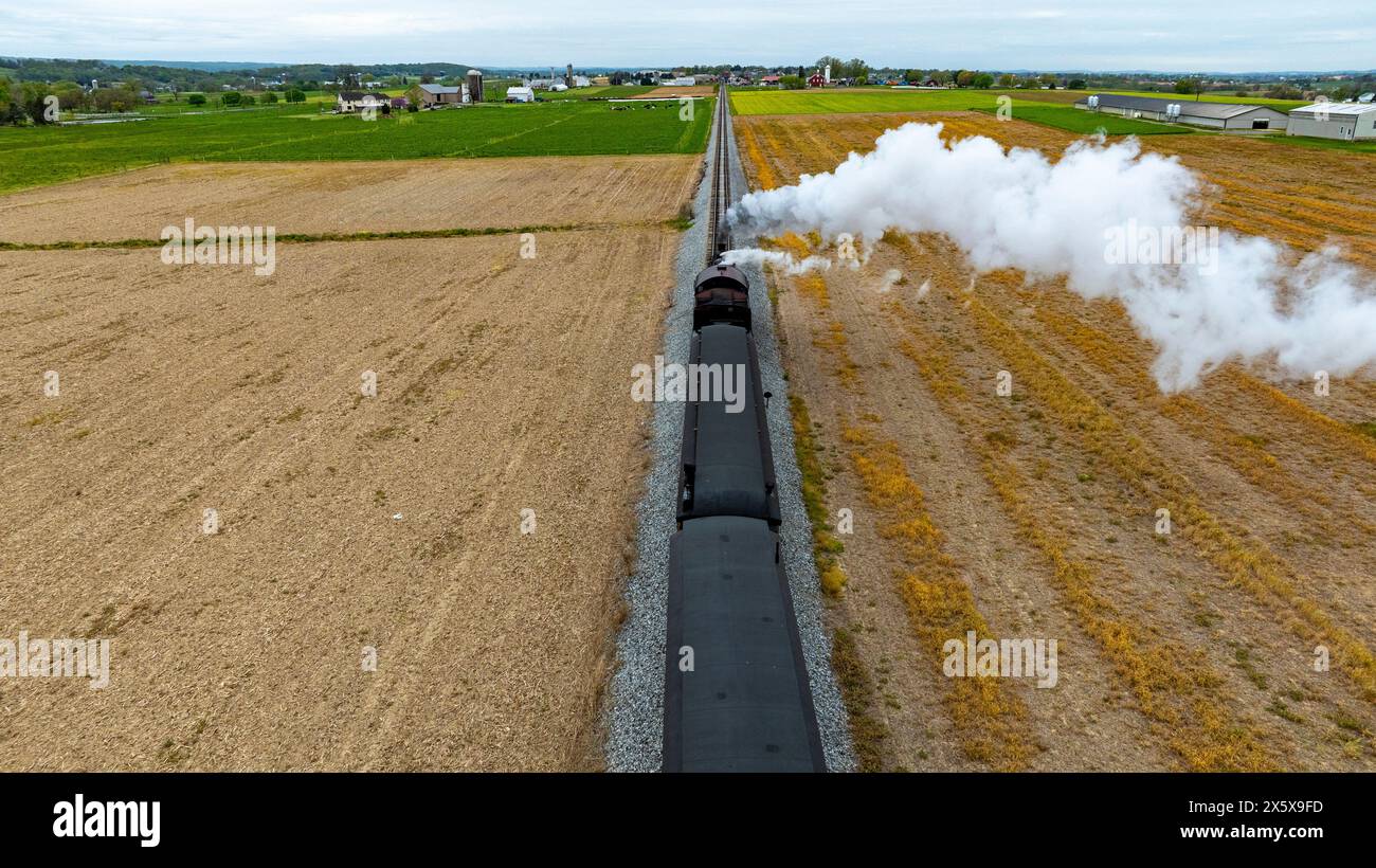 Dramatic top-down view of a steam train emitting a thick cloud of smoke ...
