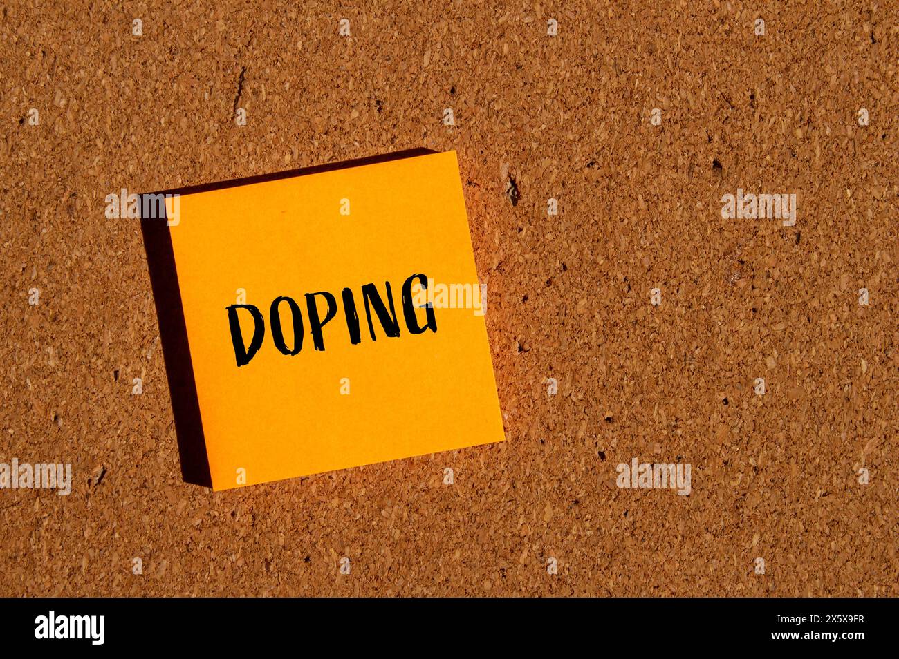 Doping word written on orange paper sticker with brown background ... Doping word written on orange paper sticker with brown background ...