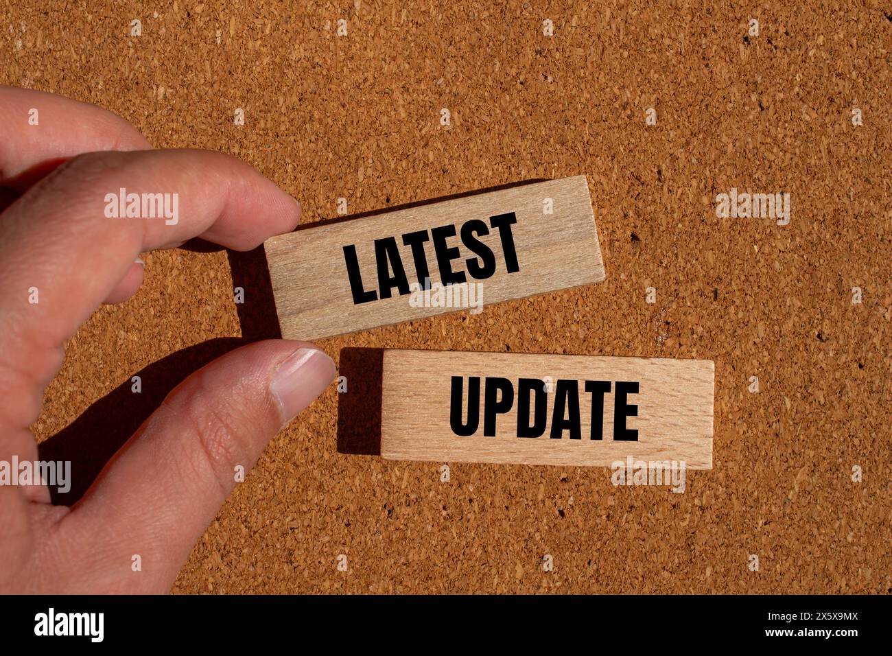 Latest update words written on wooden blocks with brown background ...