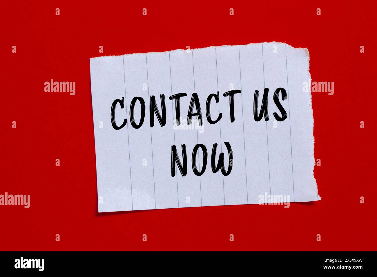 Contact us now words written on ripped paper with red background ...