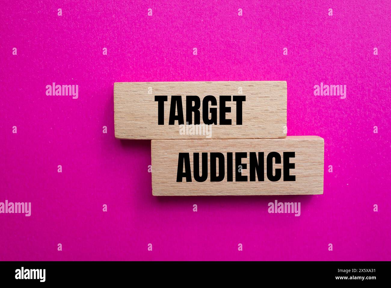 Target audience words written on wooden blocks with pink background ...