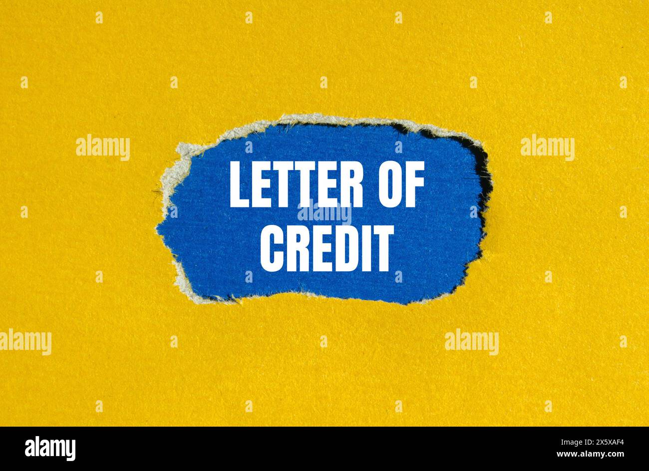 Letter of credit words written on ripped yellow paper with blue ...