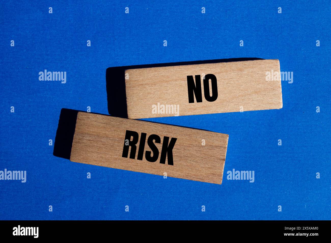 No risk words written on wooden blocks with blue background. Conceptual ...