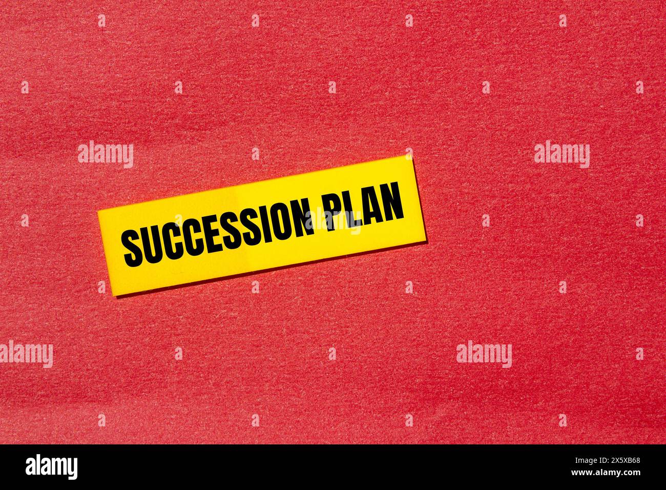 Succession plan words written on yellow paper sticker with red ...