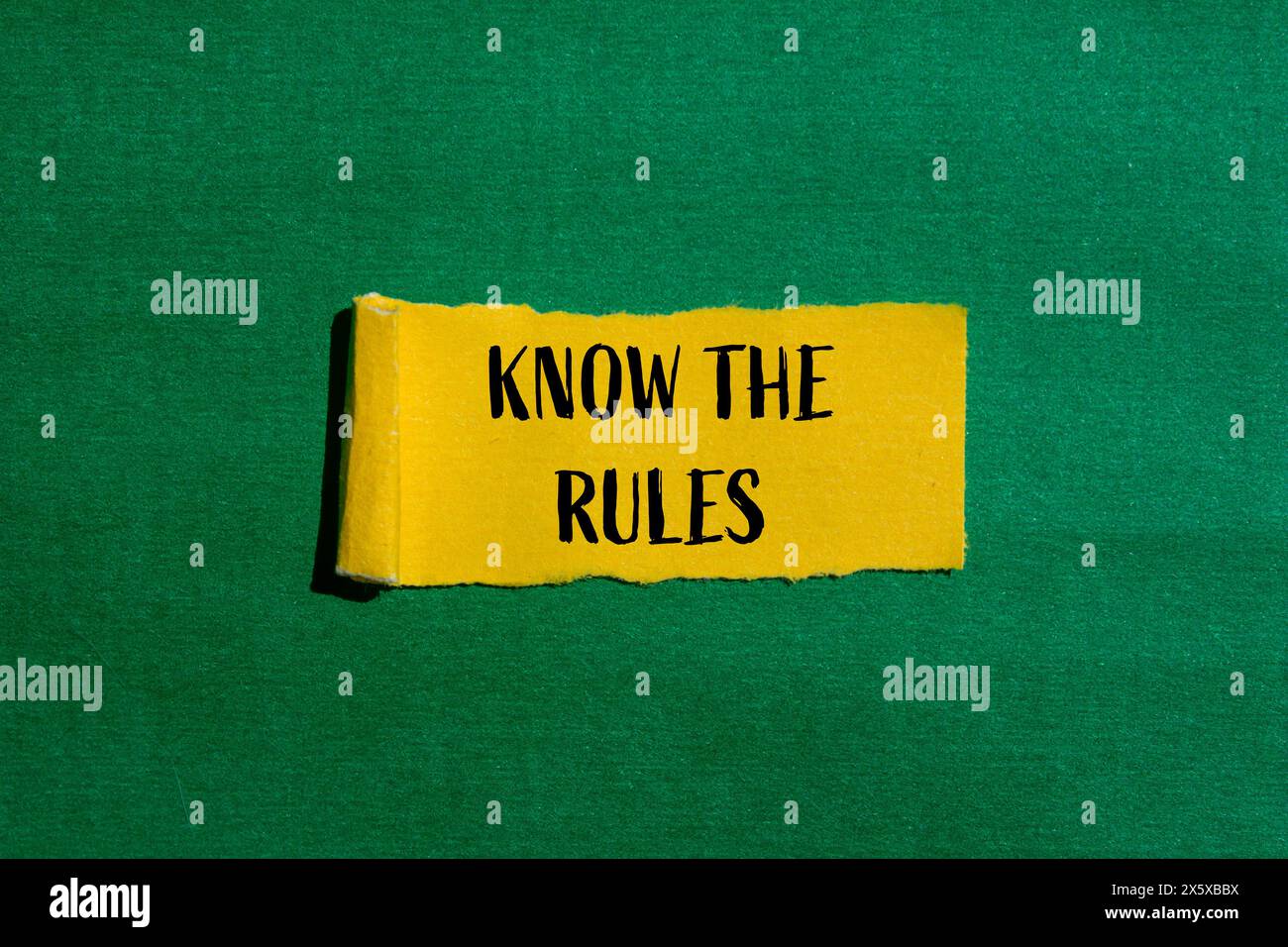Know the rules words written on ripped yellow paper with green ...