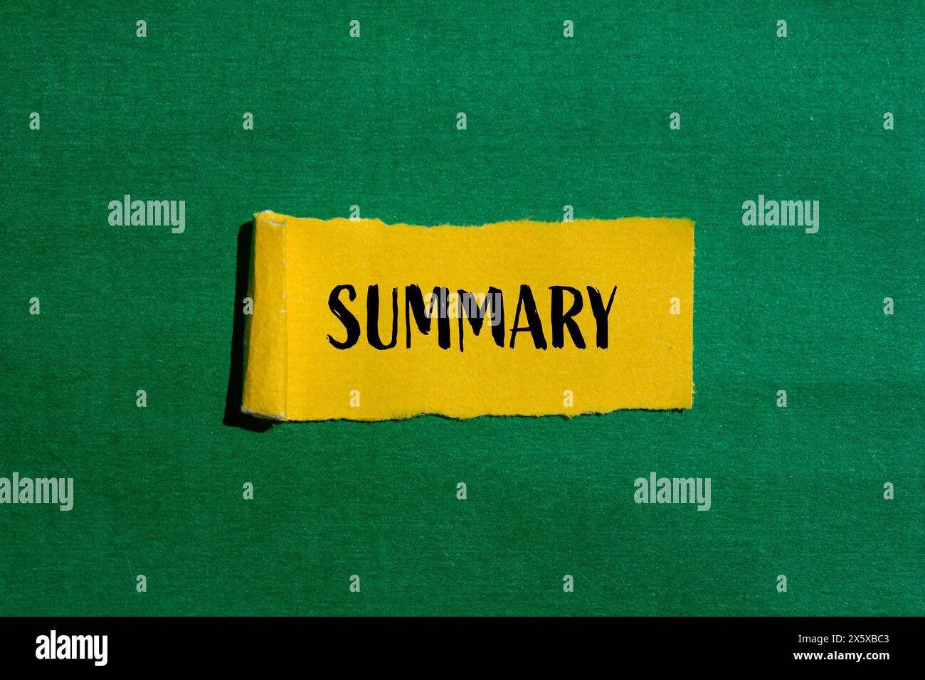 Summary word written on ripped yellow paper with green background ...